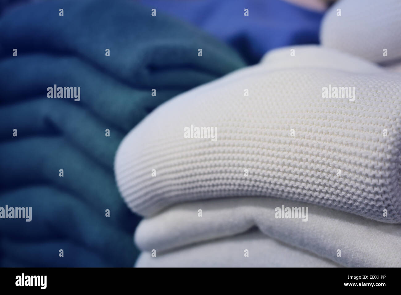 Stacks of clothes in store, close up view Stock Photo - Alamy