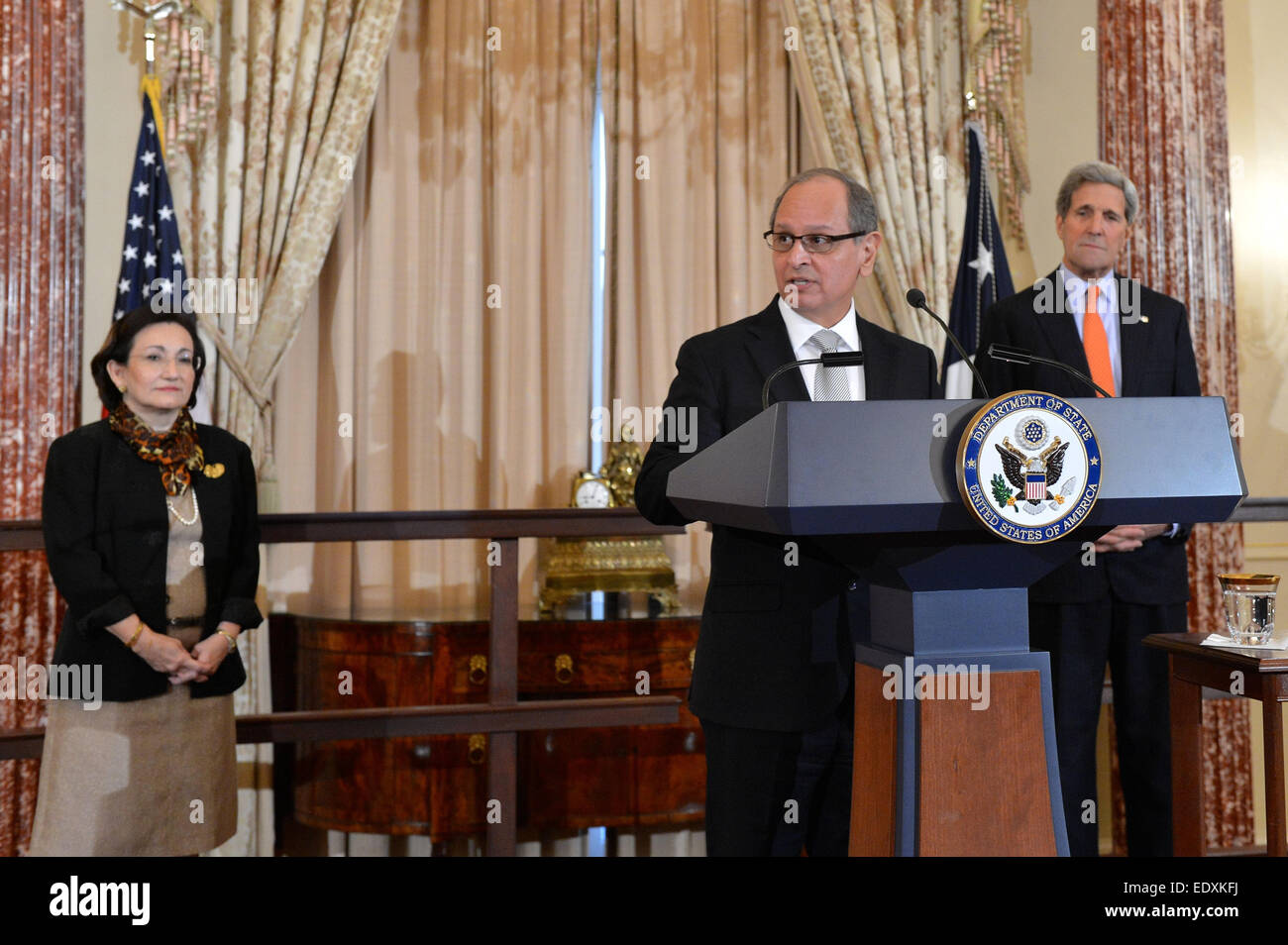 With his wife, Alida Chacon, and U.S. Secretary of State John Kerry ...