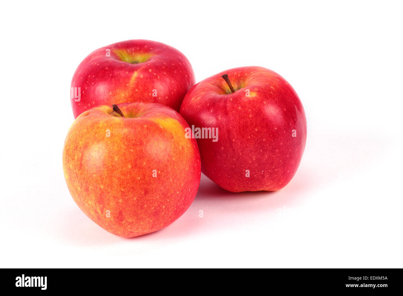Three red apples closeup on a white background Stock Photo - Alamy