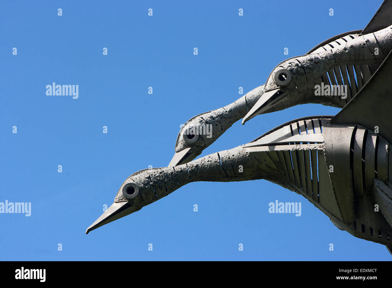 Detail of metal sculpture of three mallard ducks about to land by ...