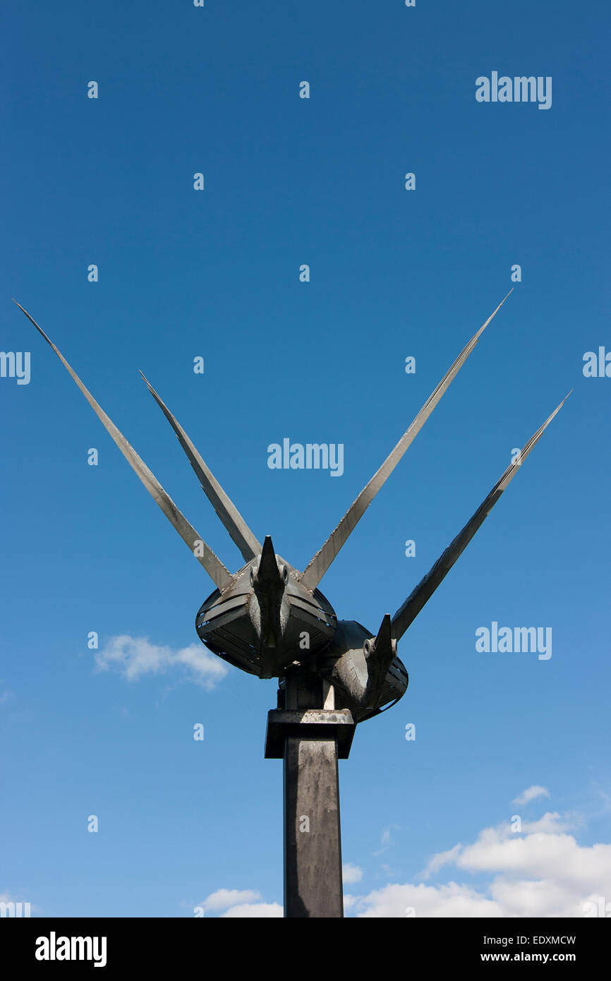 Detail of metal sculpture of two swans about to land by British ...