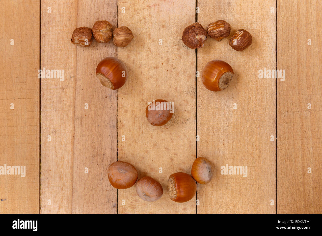 face of nuts on wooden boards Stock Photo - Alamy