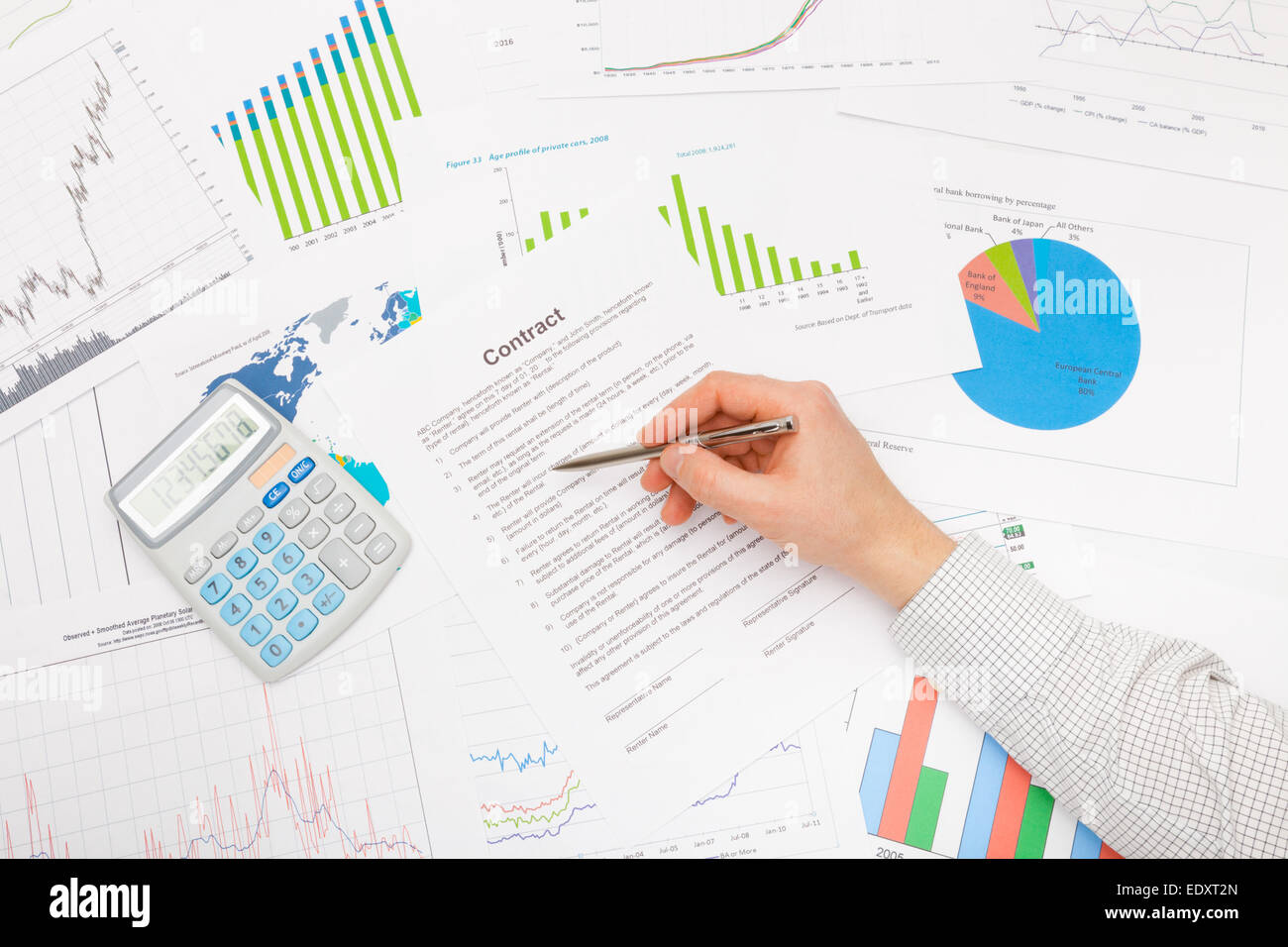 Male hand and financial charts and graphs Stock Photo - Alamy