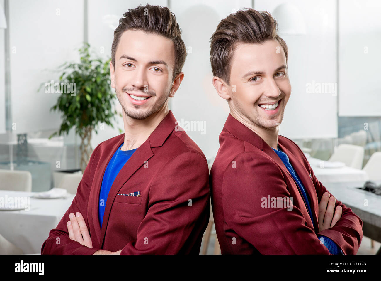 Adult brothers back to back not talking hi-res stock photography and ...