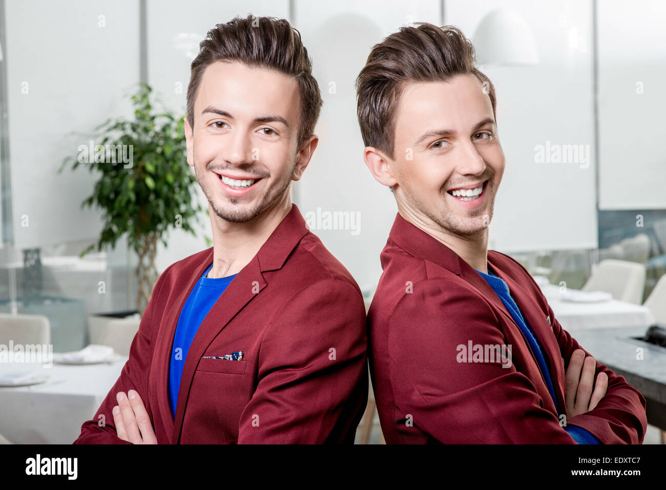 Adult brothers back to back not talking hi-res stock photography and ...