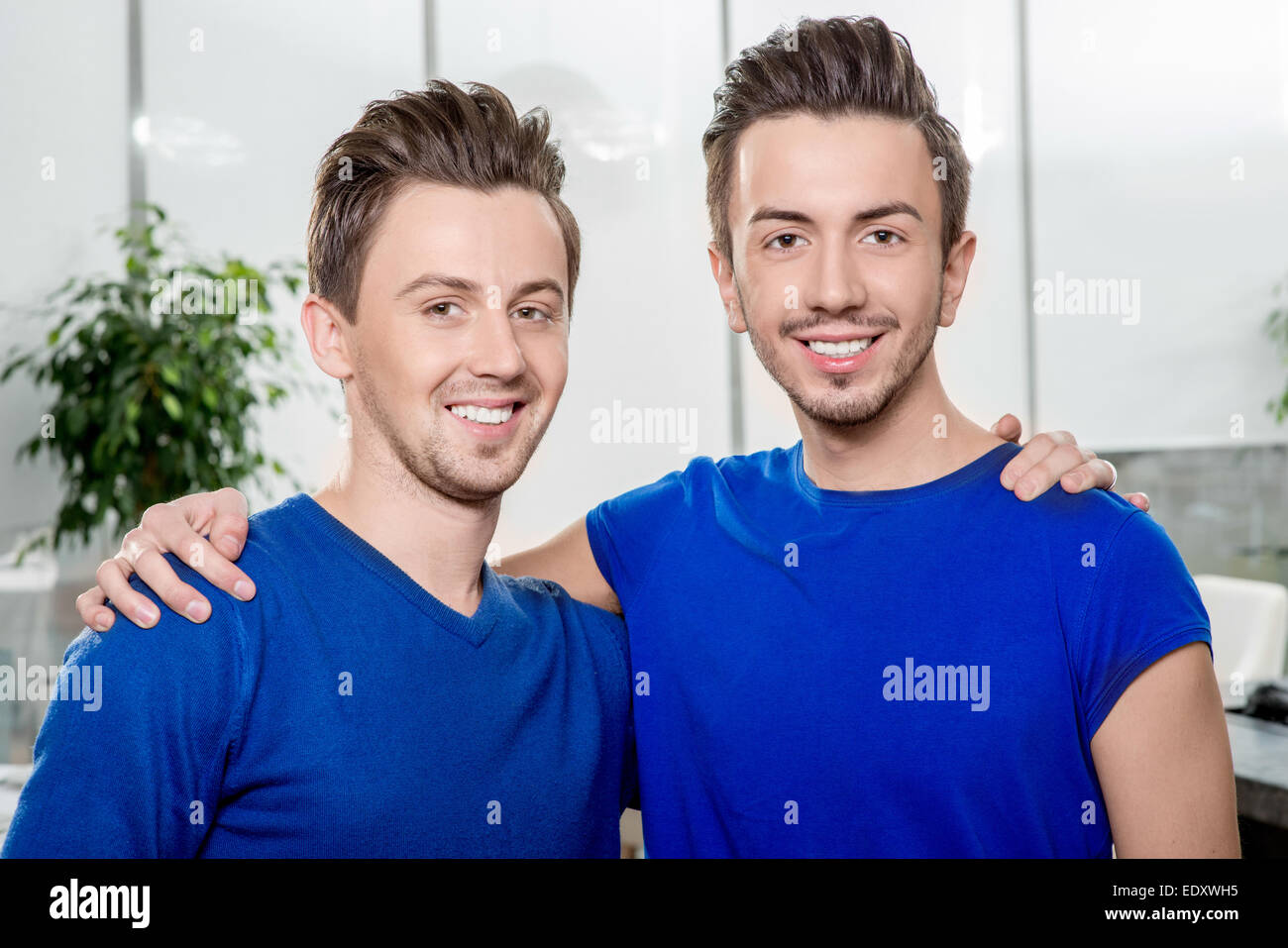 Twins embrace hi-res stock photography and images - Alamy
