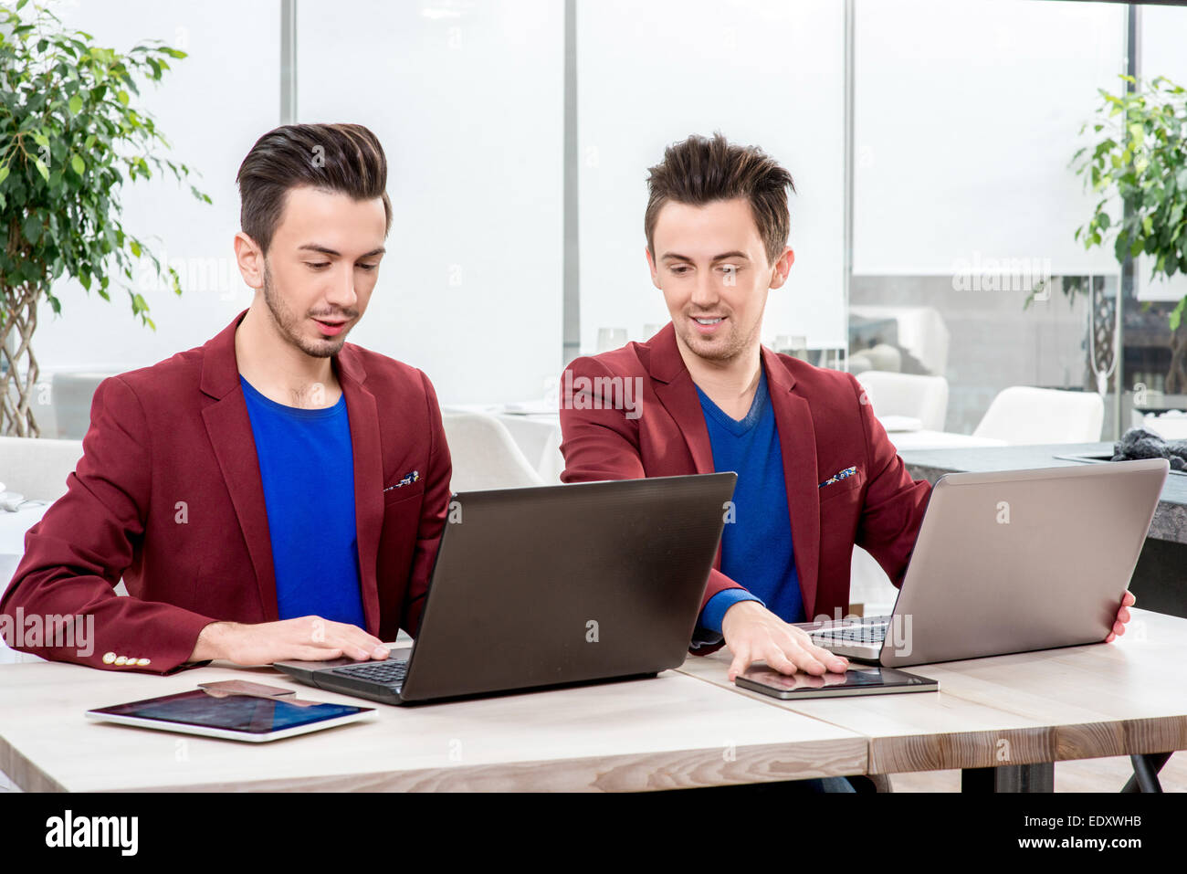 Two brothers twins working at the office Stock Photo - Alamy