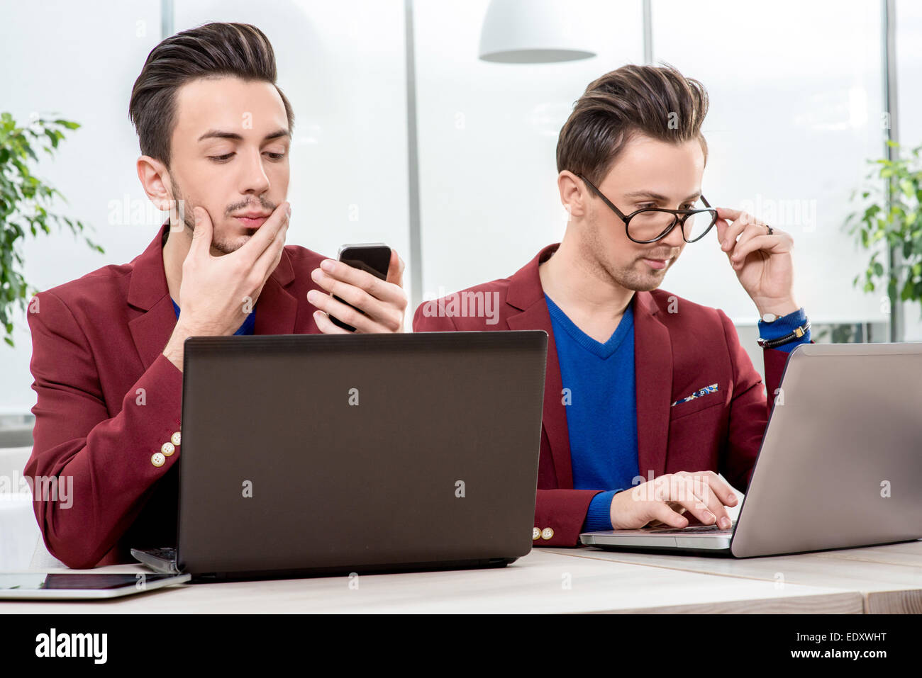 Two brothers twins working at the office Stock Photo - Alamy