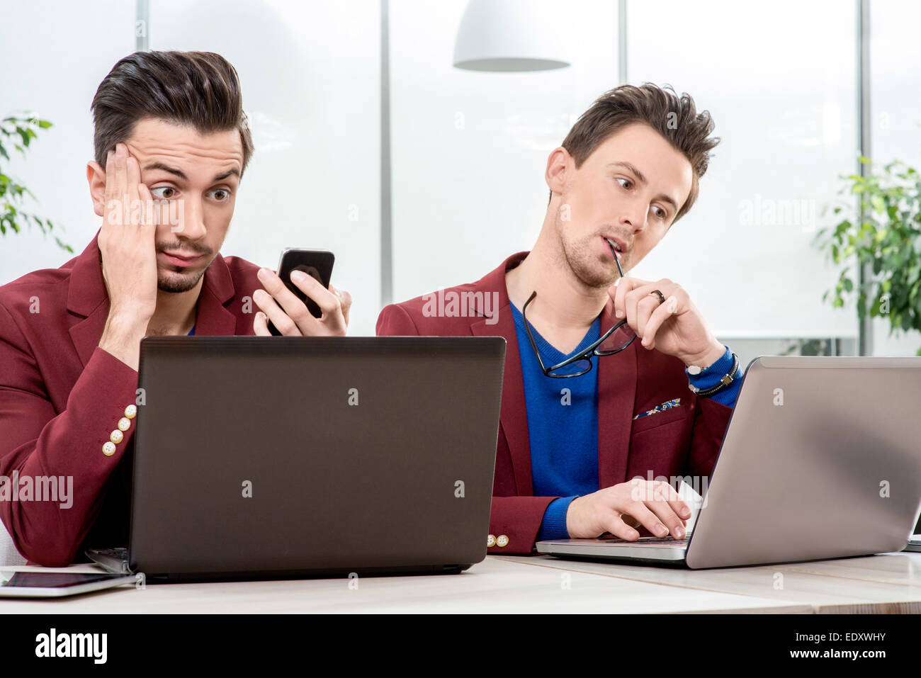 Two brothers twins working at the office Stock Photo - Alamy