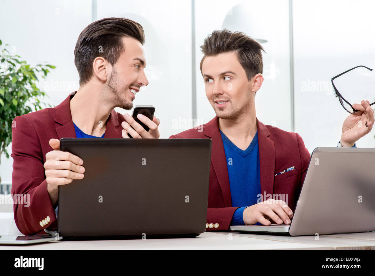 Two brothers twins working at the office Stock Photo - Alamy