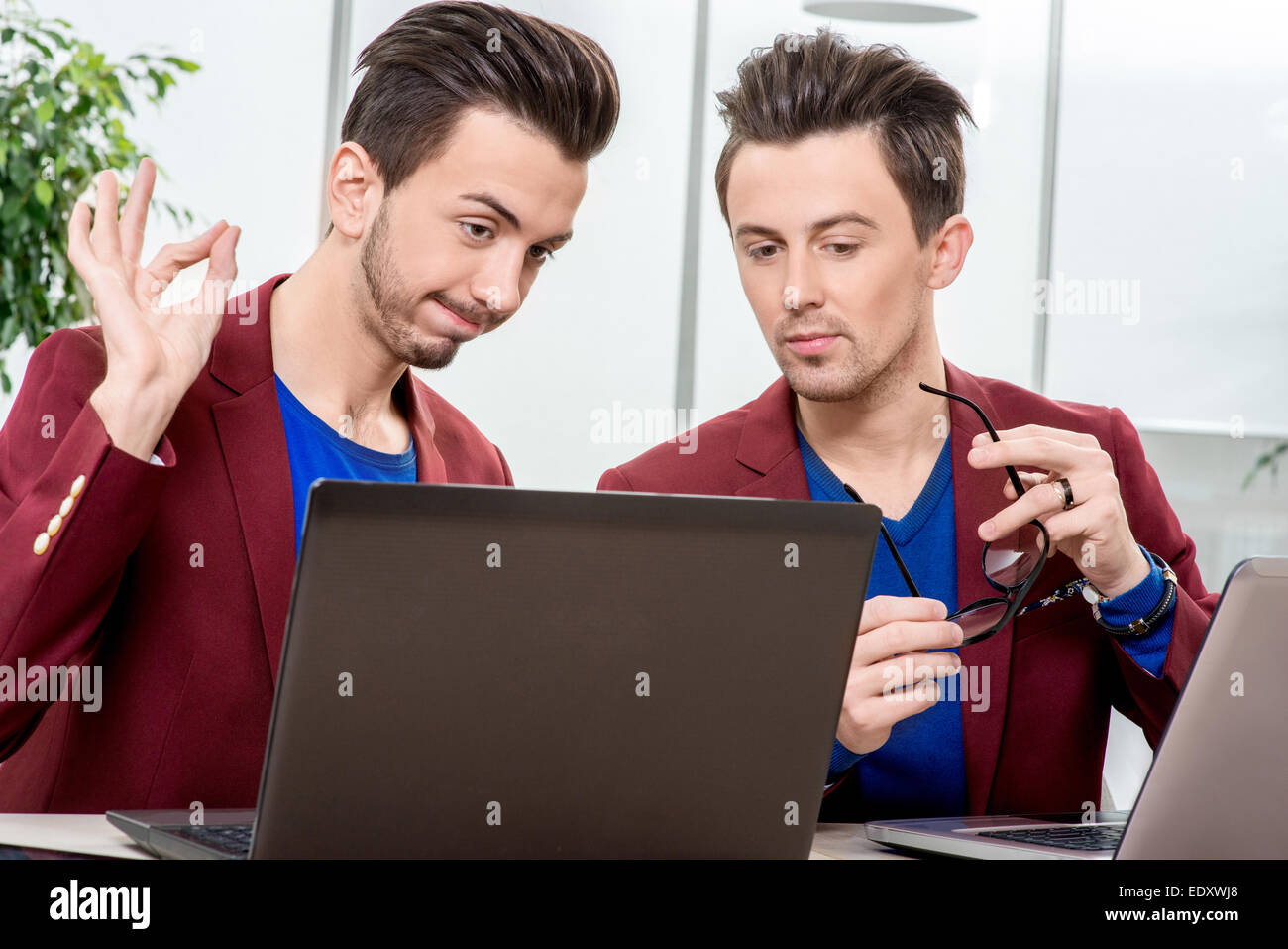 Two brothers twins working at the office Stock Photo - Alamy