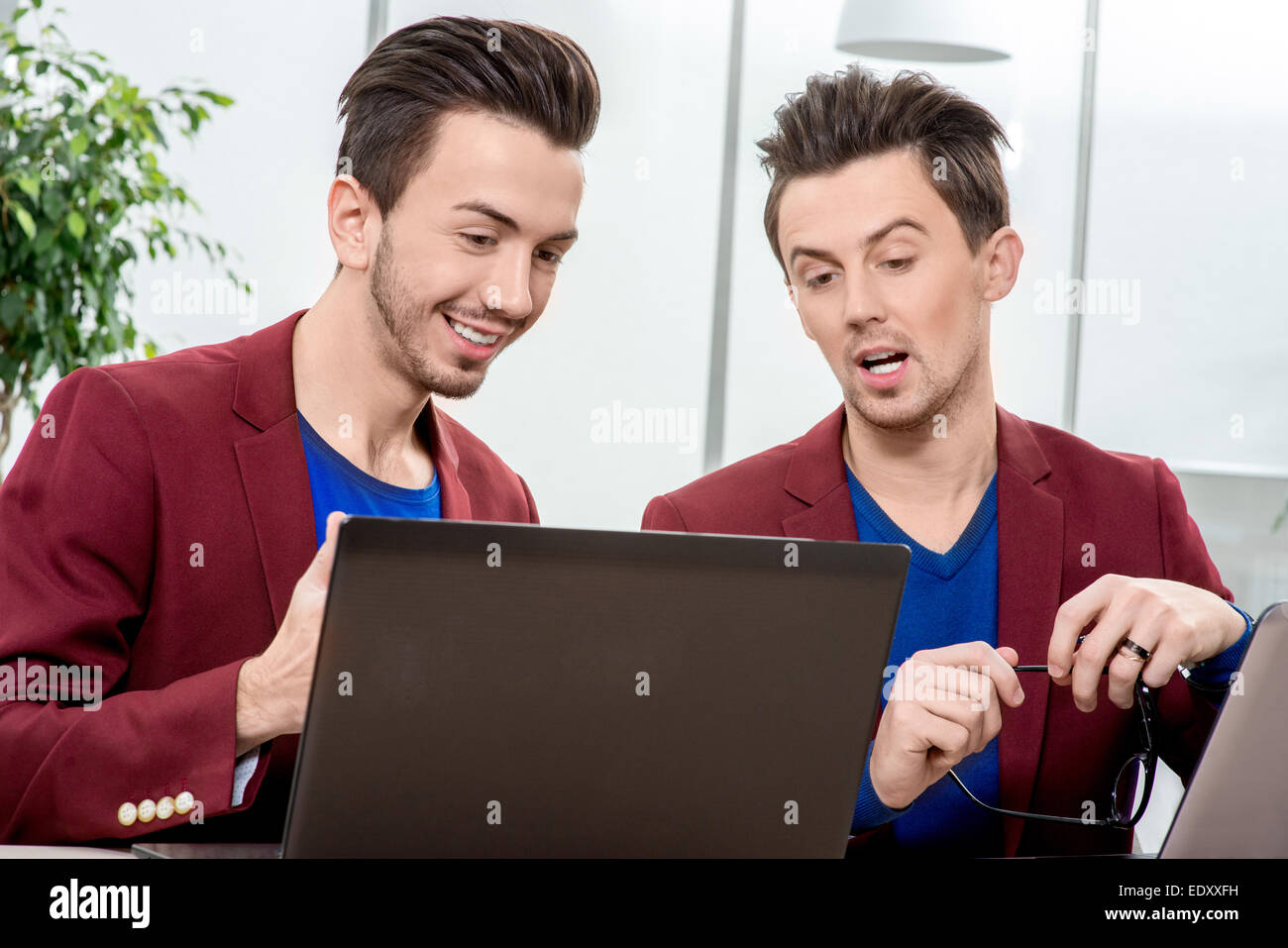 Two brothers twins working at the office Stock Photo - Alamy