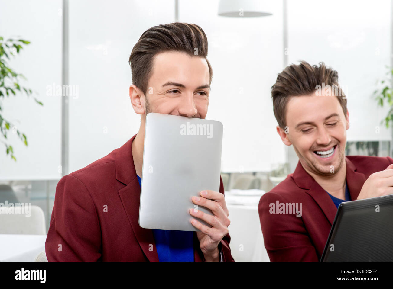 Two brothers twins working at the office Stock Photo - Alamy