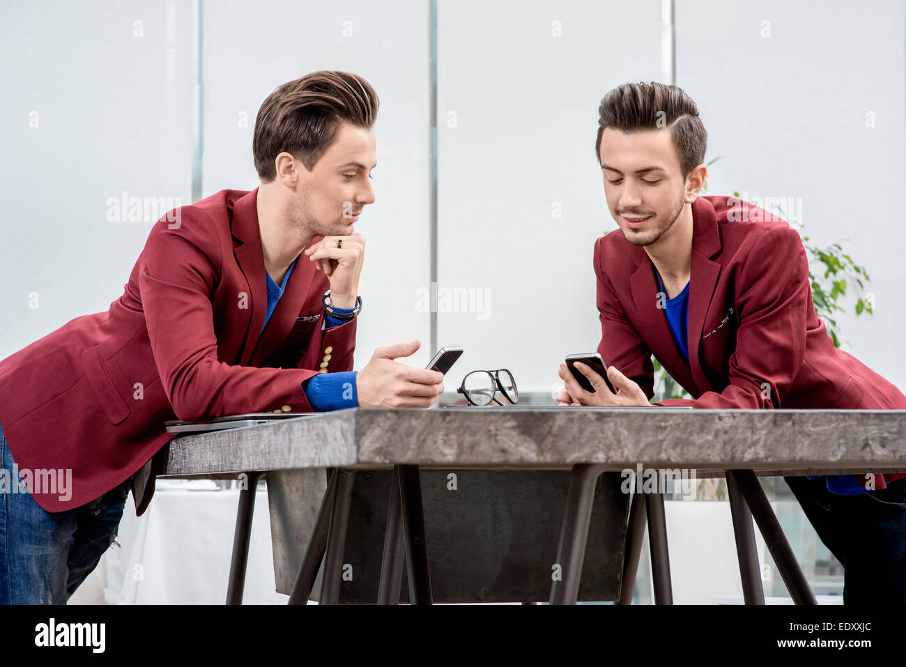 Two brothers twins working at the office Stock Photo - Alamy