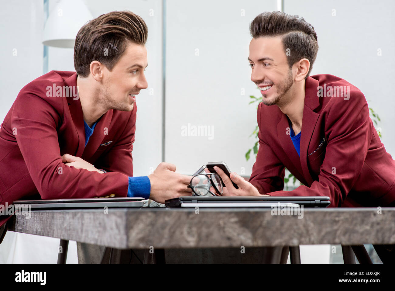 Two brothers twins working at the office Stock Photo - Alamy