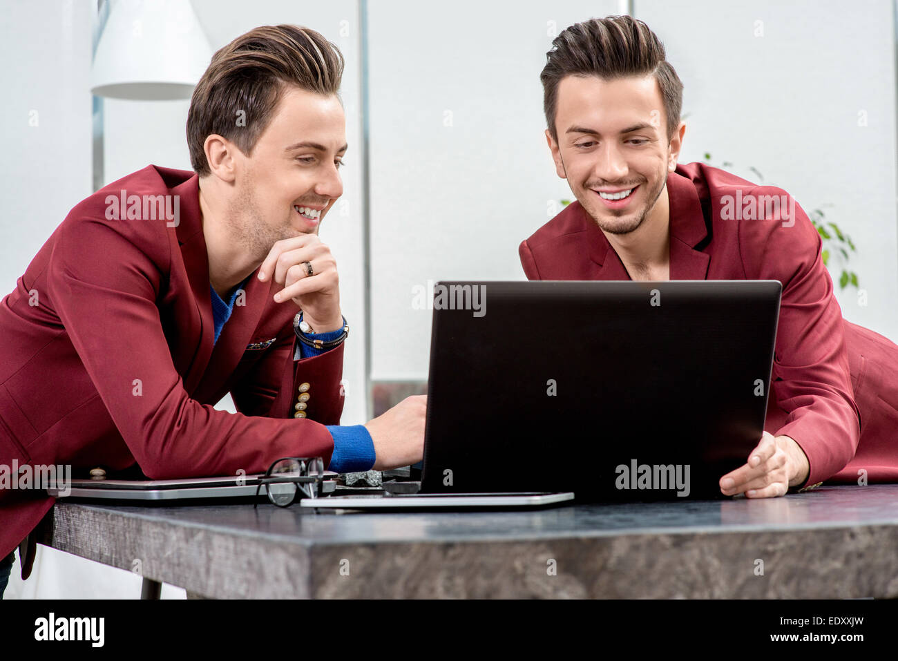 Two brothers twins working at the office Stock Photo - Alamy