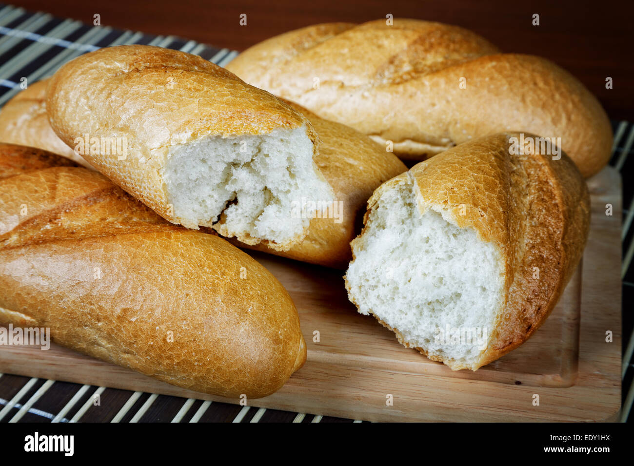 Pile of white rolls on a kitchen table Stock Photo - Alamy