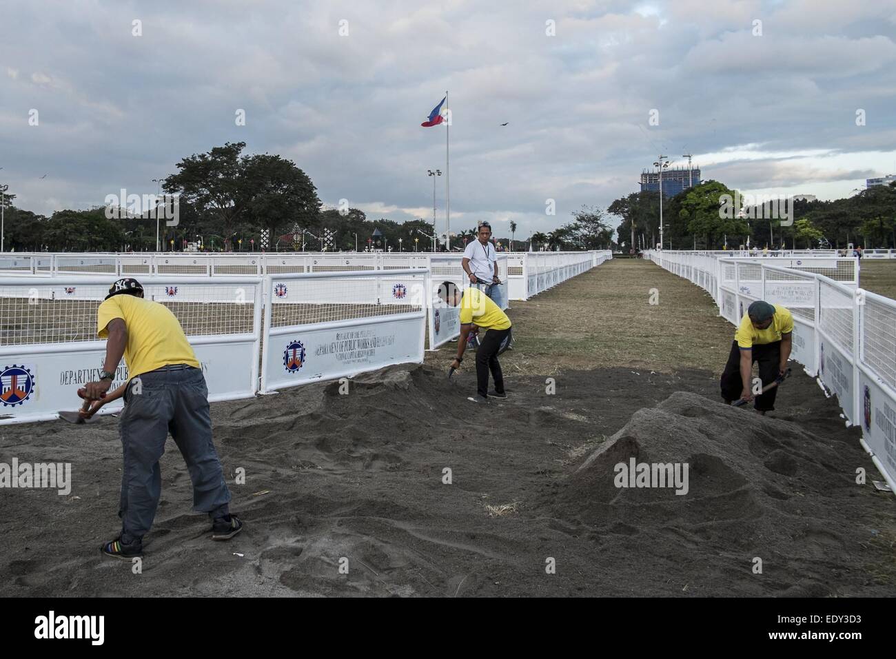 Department of Public Works and Highways (DPWH) personnels patch uneven ...