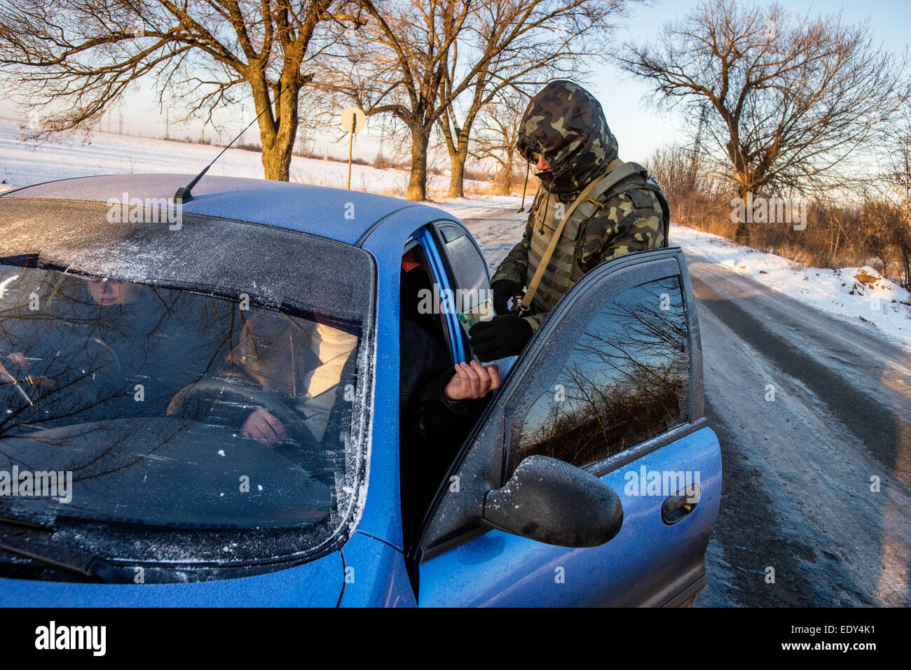 Soldiers checking cars in checkpoint at front line between DNR ...