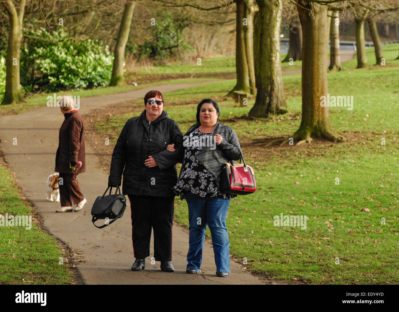 Two ladies walking in the park Stock Photo - Alamy