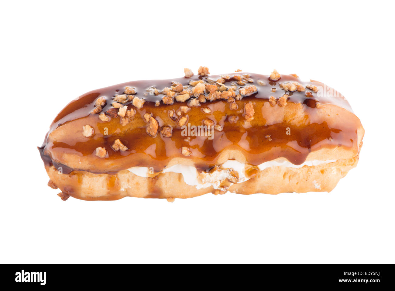 Eclair with caramel decoration on white reflective background Stock ...
