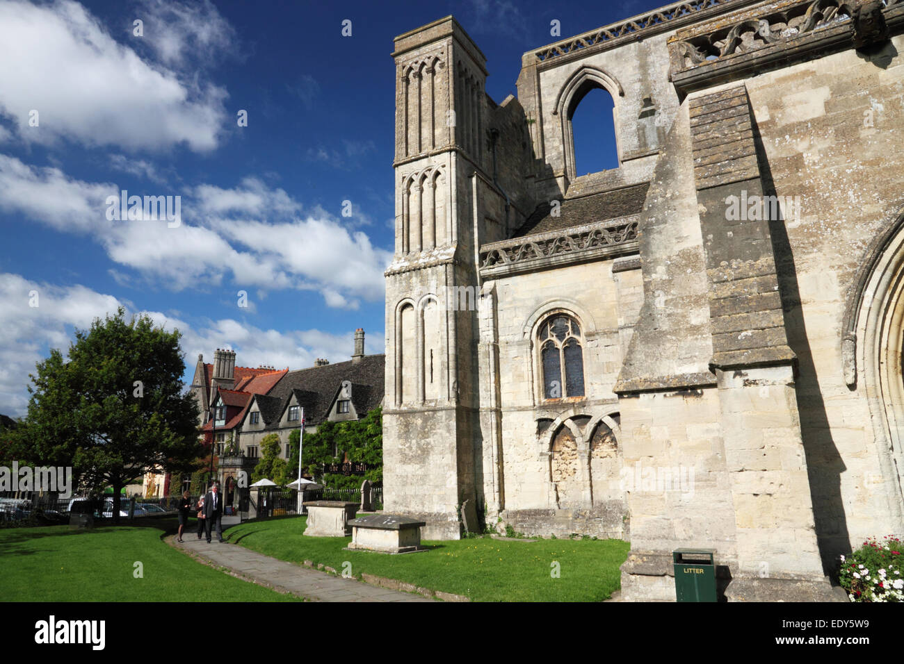 A medieval abbey with a tower and buildings beyond Stock Photo - Alamy