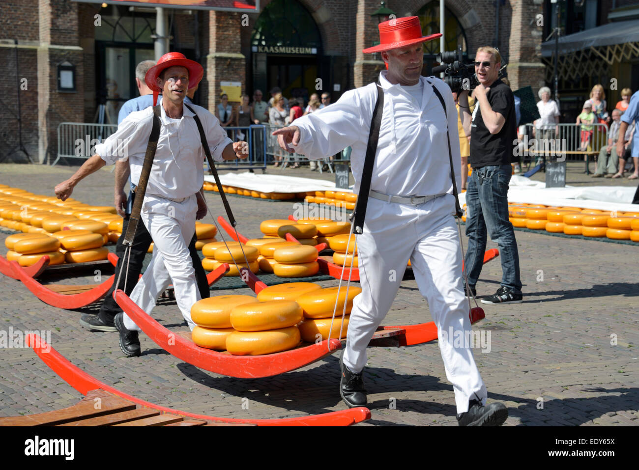 Cheese porters carrying cheese wheels on wooden sledges at the Friday ...
