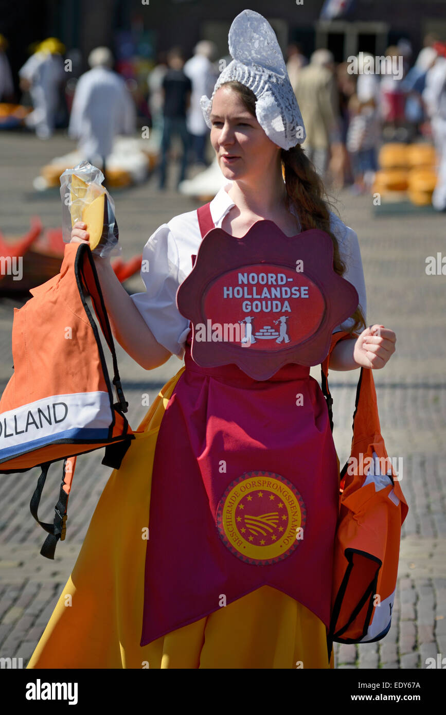 Girl in traditional Dutch costume selling cheese at the cheese market ...