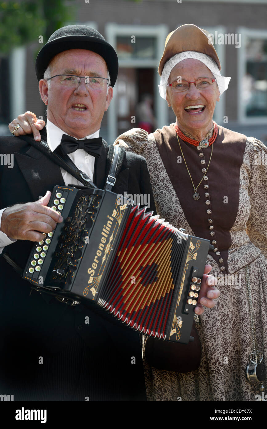 Couple in traditional Dutch costume singing and playing a Squeezebox ...
