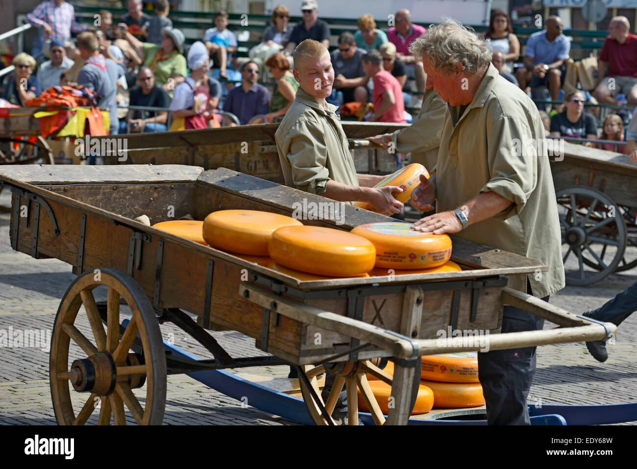 Loading cheese wheels onto a traditional wooden cart, Waagplein Square ...