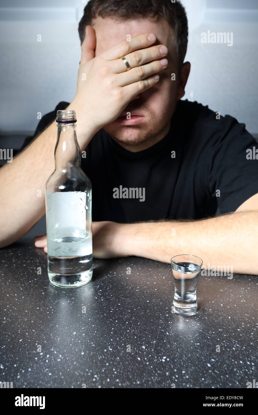 Alcohol problem - helpless man drinking vodka Stock Photo - Alamy