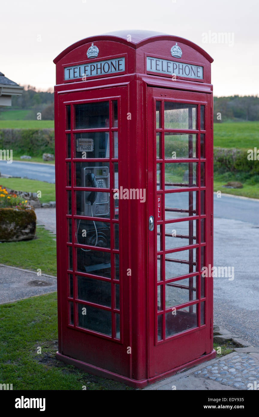 Close-up of traditional bright red telephone box or kiosk standing by ...