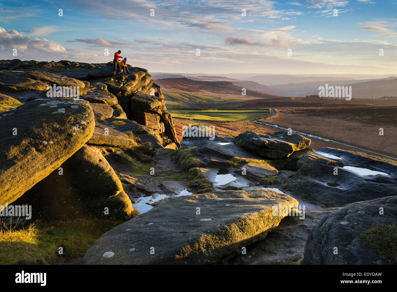 Climbers on Stanage Edge in Peak District during sunset landscape Stock ...