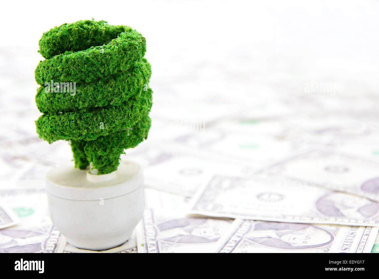 Eco light bulb with cash Stock Photo - Alamy