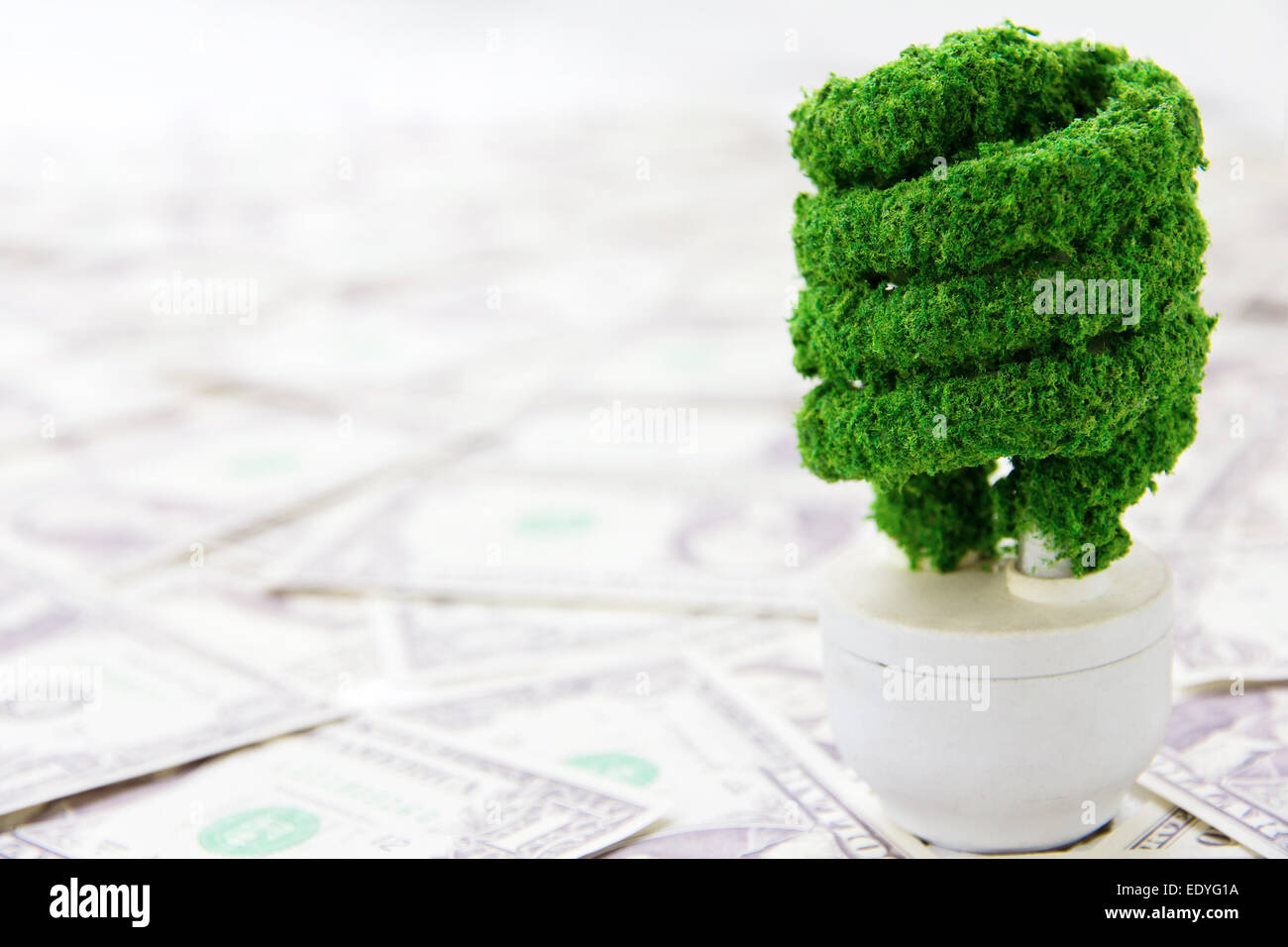 Eco light bulb with cash Stock Photo - Alamy