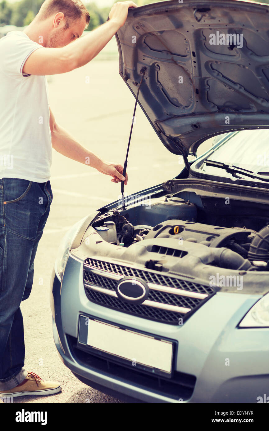 man opening car bonnet Stock Photo - Alamy