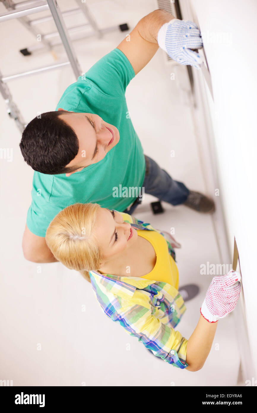 smiling couple doing renovations at home Stock Photo - Alamy