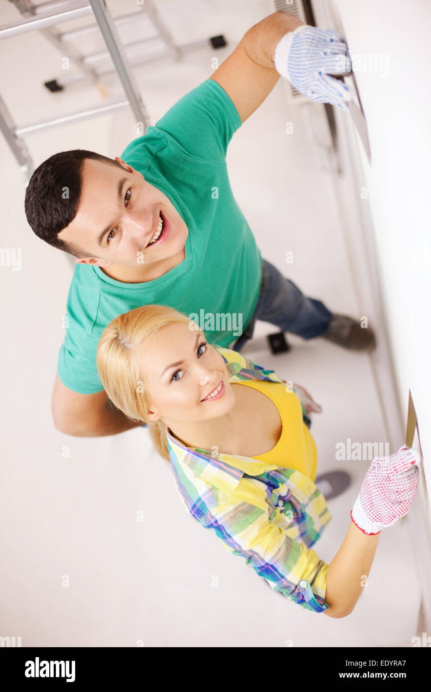 smiling couple doing renovations at home Stock Photo - Alamy