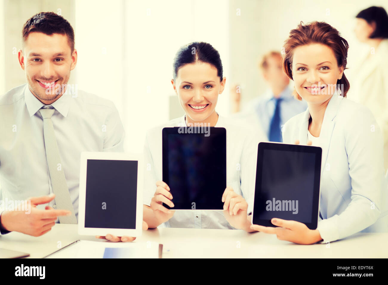 business team showing tablet pcs in office Stock Photo - Alamy