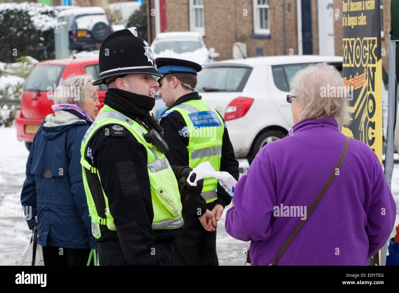 On a cold day two police officers talk to older ladies about crime ...