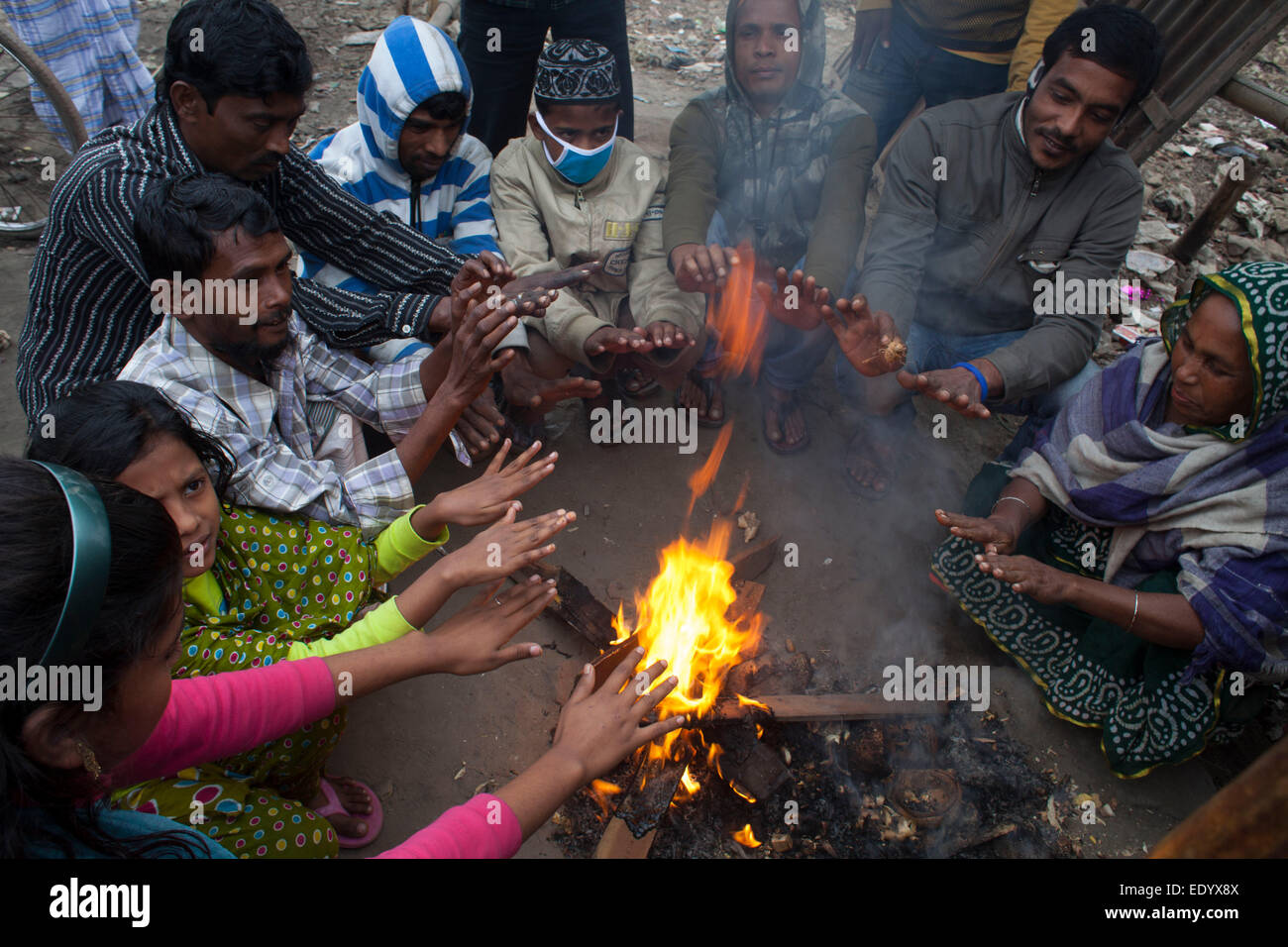 Slum people taking warm by firing woods near rail line in a winter ...