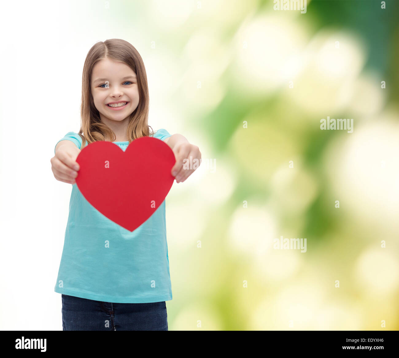smiling little girl giving red heart Stock Photo - Alamy