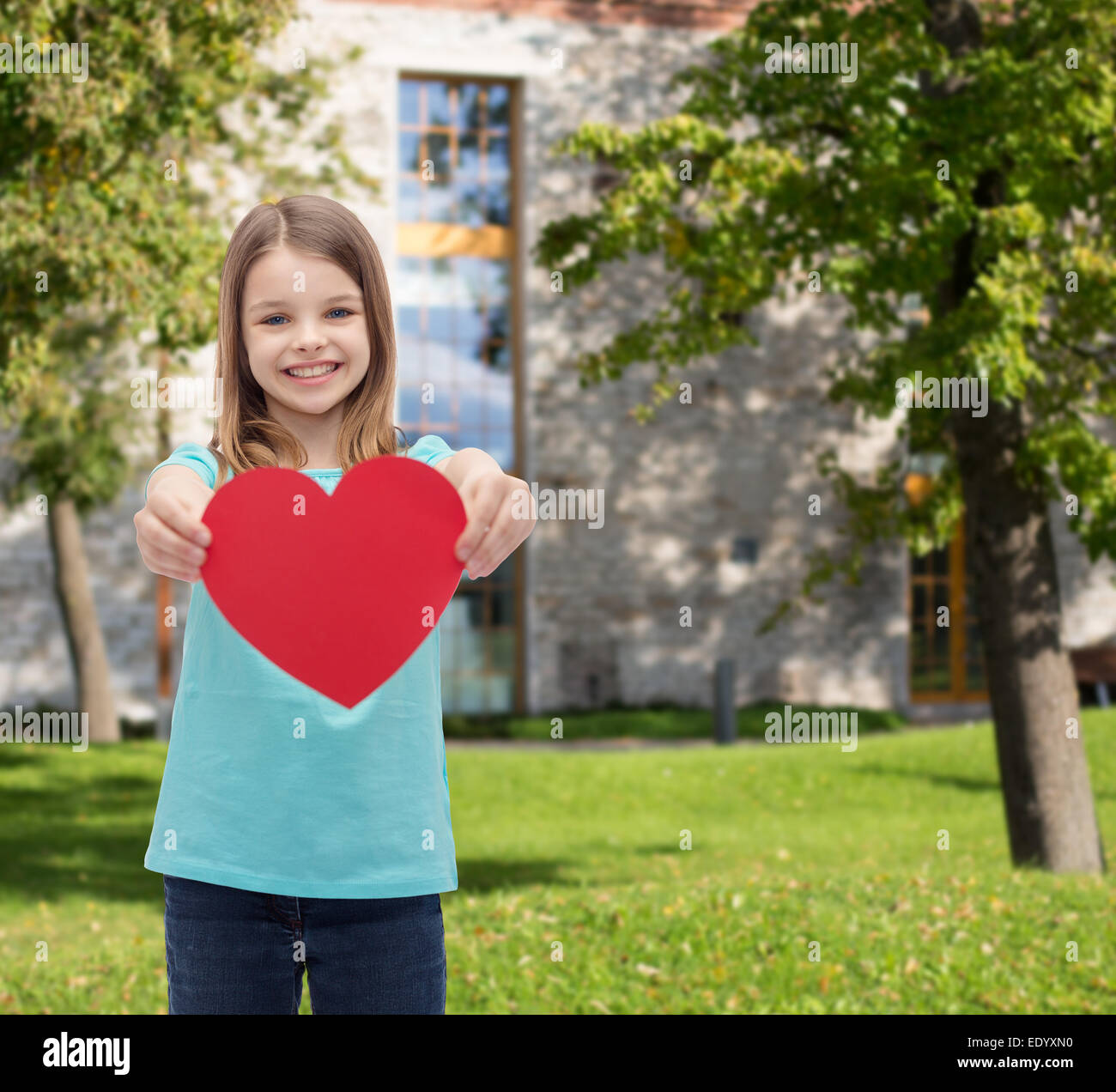 smiling little girl giving red heart Stock Photo - Alamy