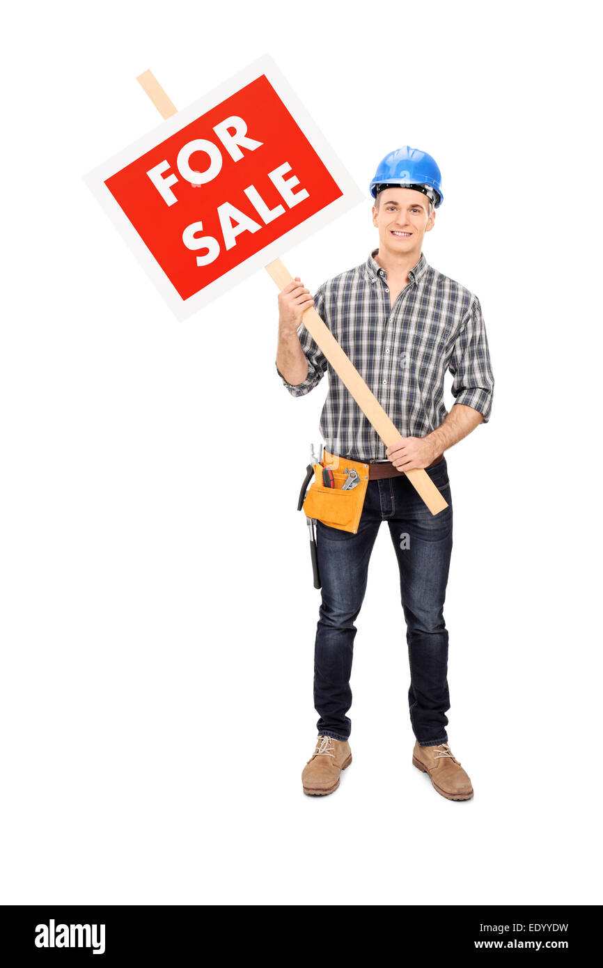 Full length portrait of a young male engineer holding a for sale sign ...