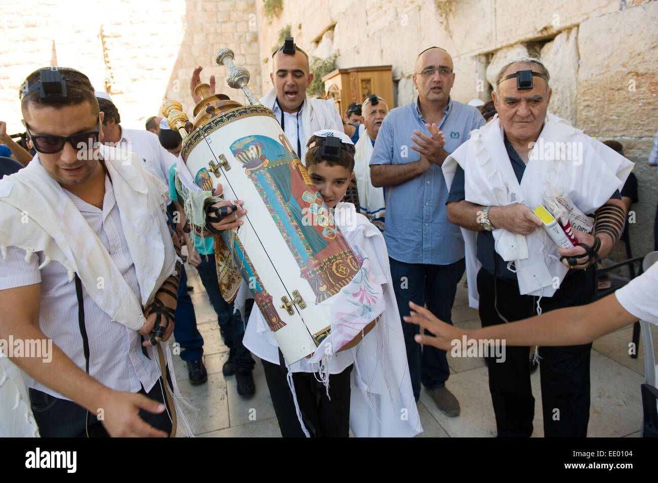 A 13 years old boy is carrying a torah scroll during a Bar Mitzvah ...