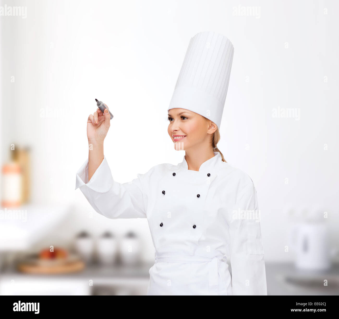 smiling female chef writing something on air Stock Photo - Alamy