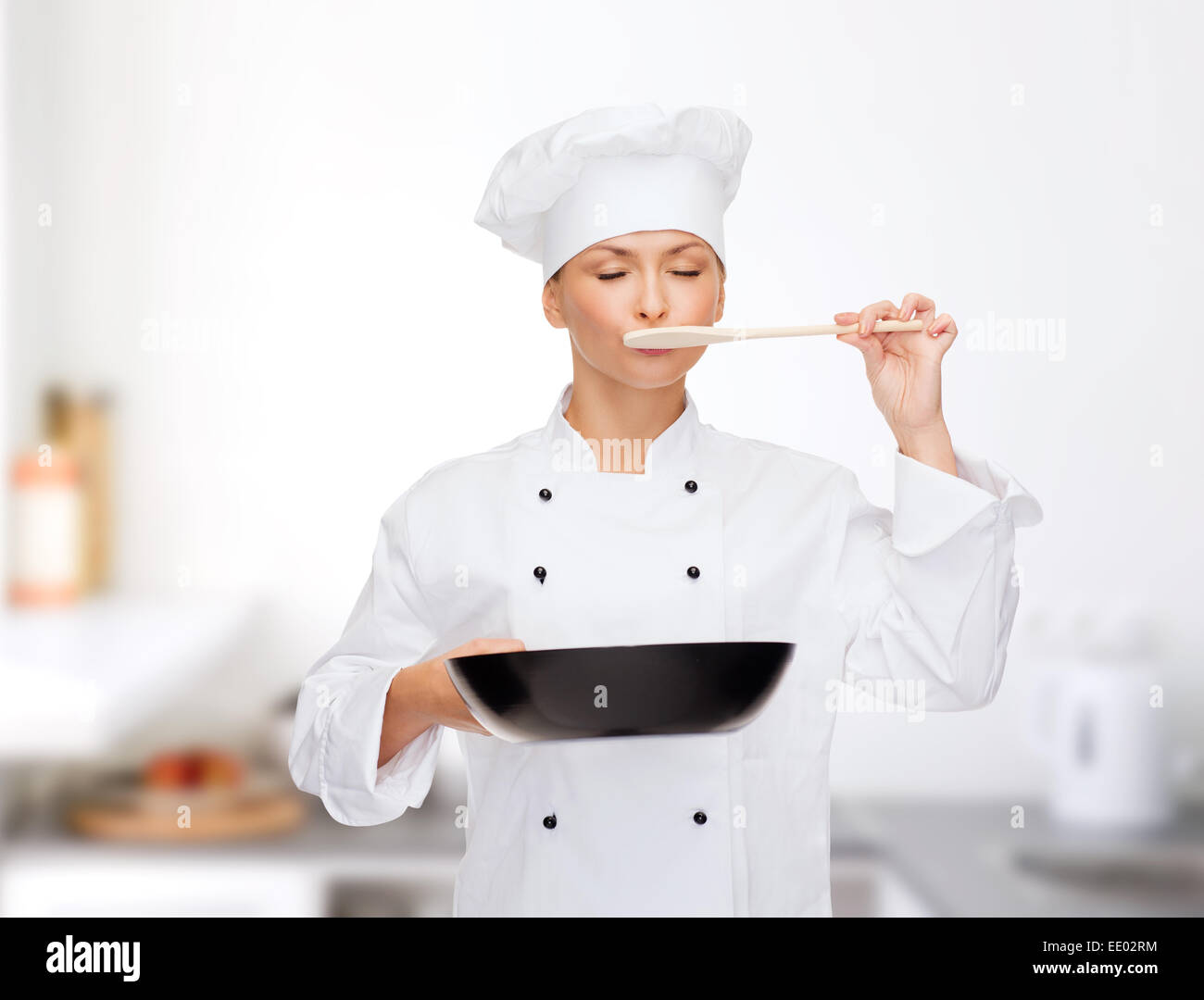 smiling female chef with pan and spoon Stock Photo - Alamy