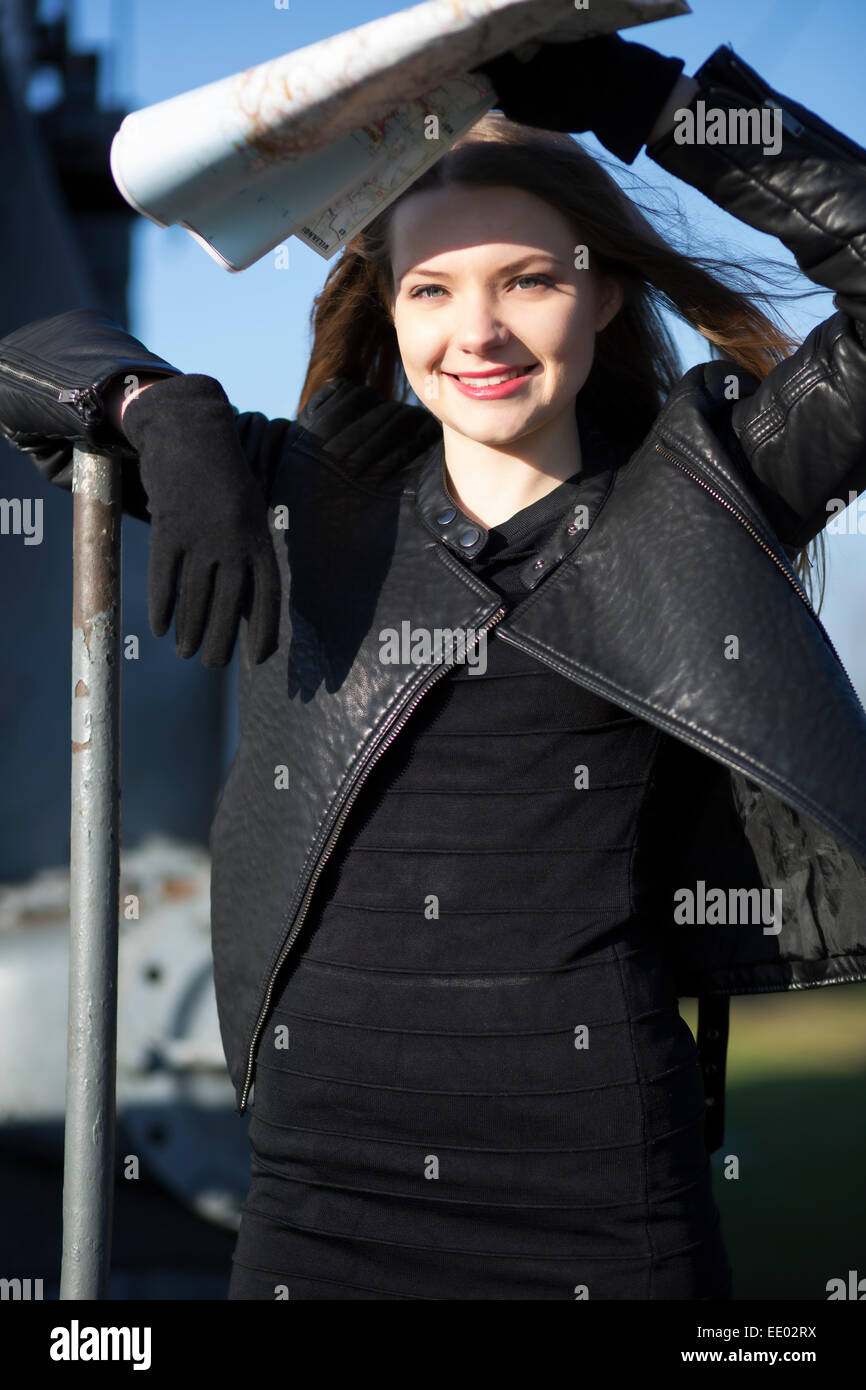 Woman at train hold route map over head Stock Photo - Alamy