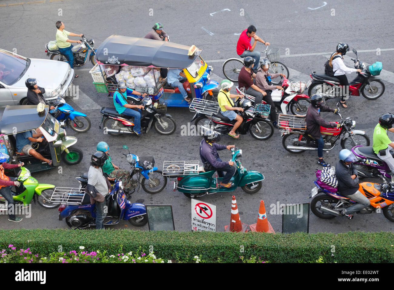 Traffic, Tuk-tuk and Vespas, bikes, bicycle waiting to cross a street ...