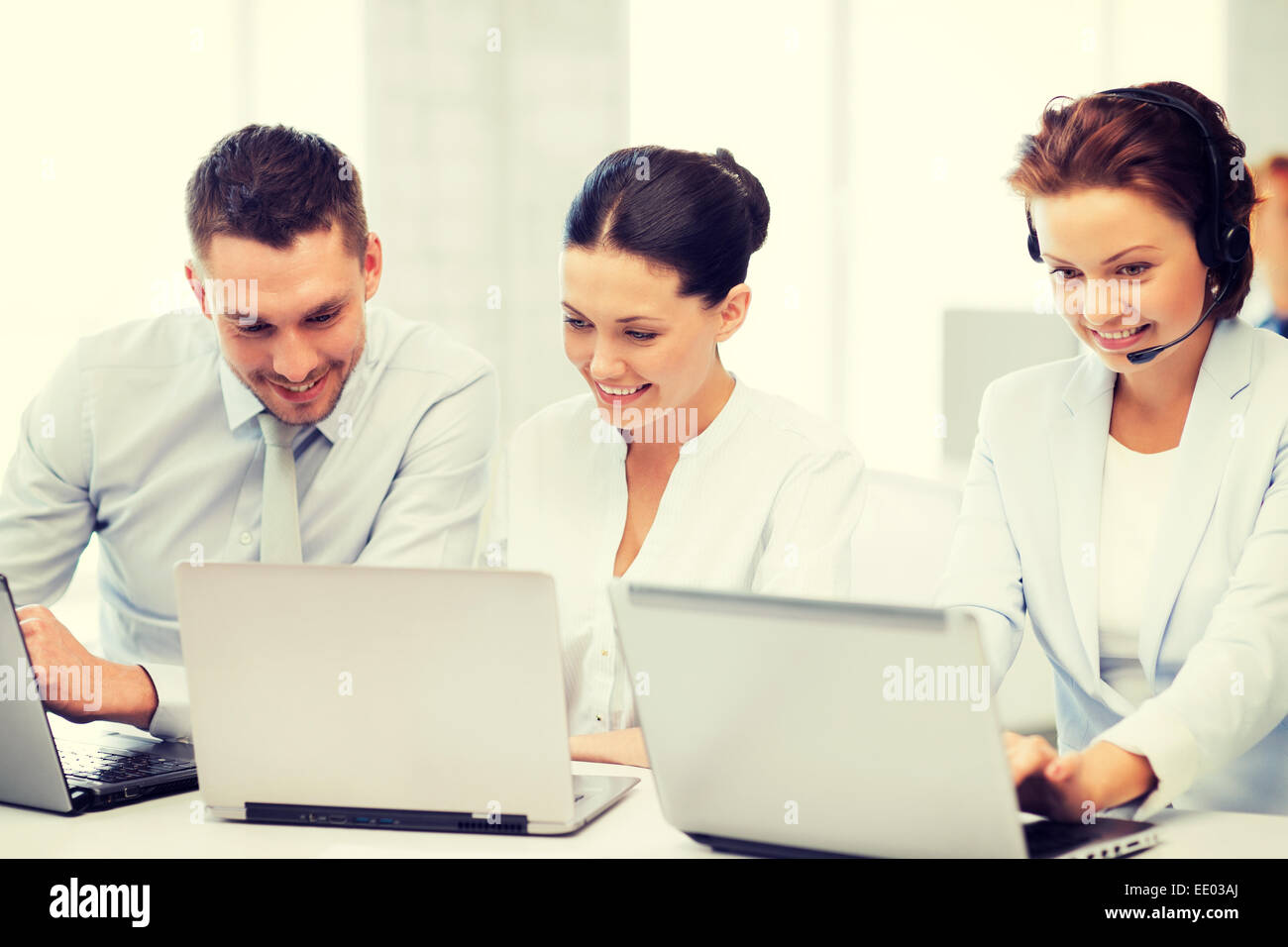 group of people working with laptops in office Stock Photo - Alamy